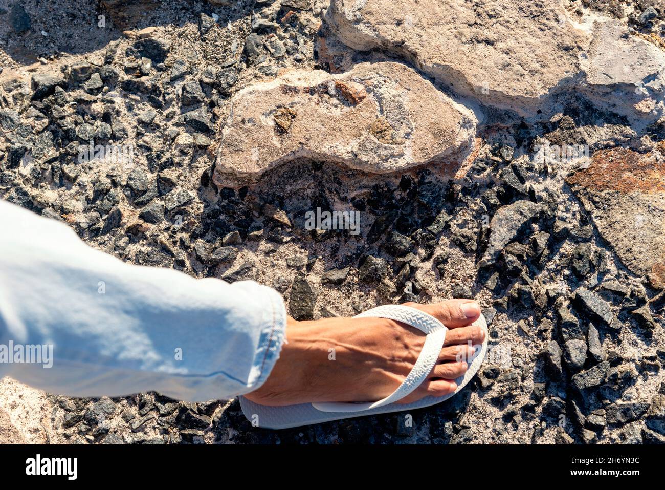 Close Up of texture of stones and a human foot on the ground. Salvador ...