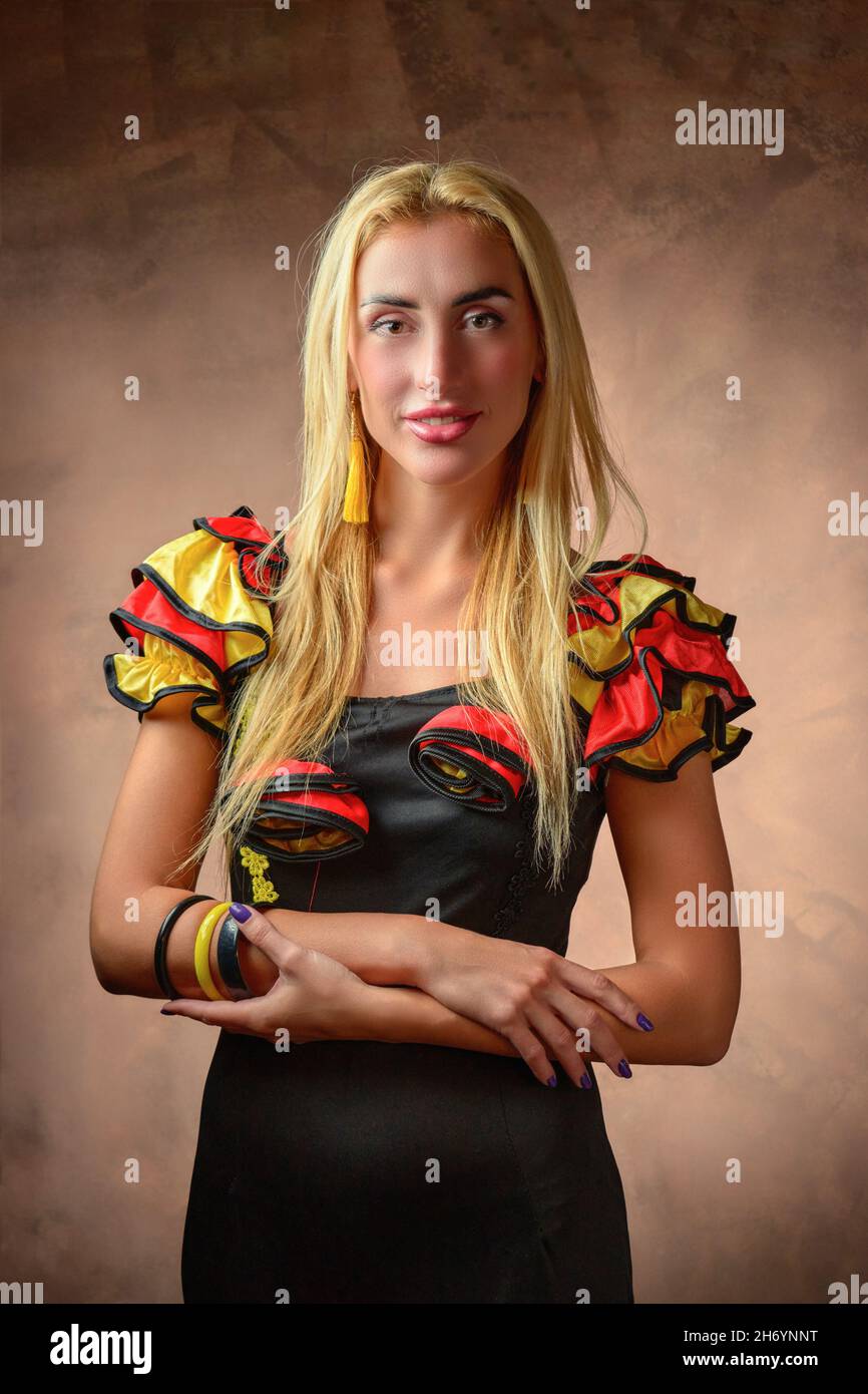 Portrait of a young blonde gypsy woman wearing a traditional dress ...