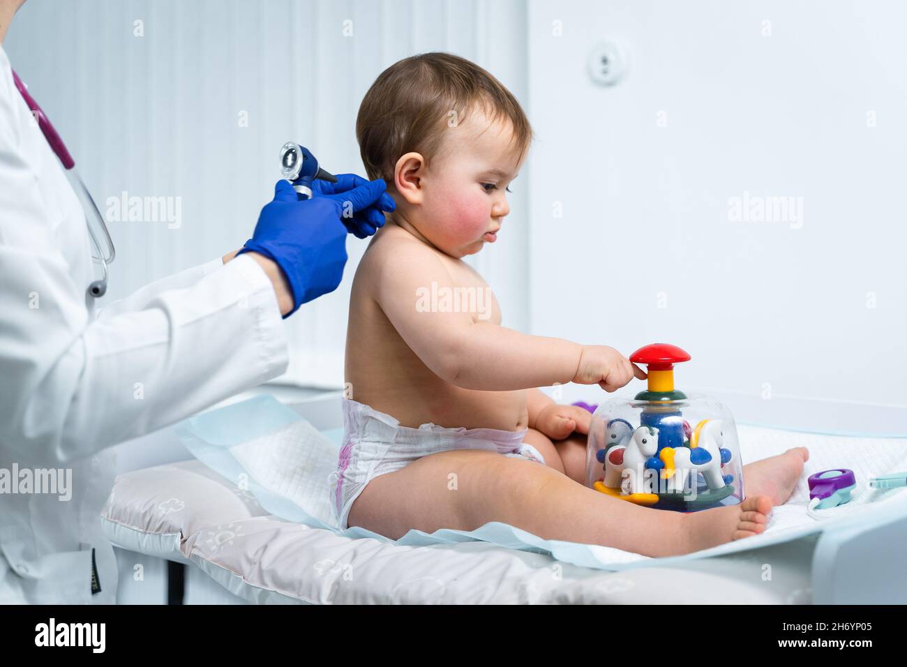 Little girl at doctor for checkup. Doctor pediatrician and baby patient ...