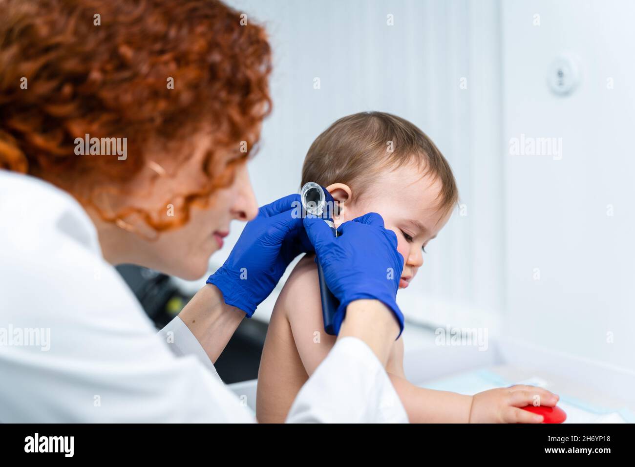 Little girl at doctor for checkup. Doctor pediatrician and baby patient ...