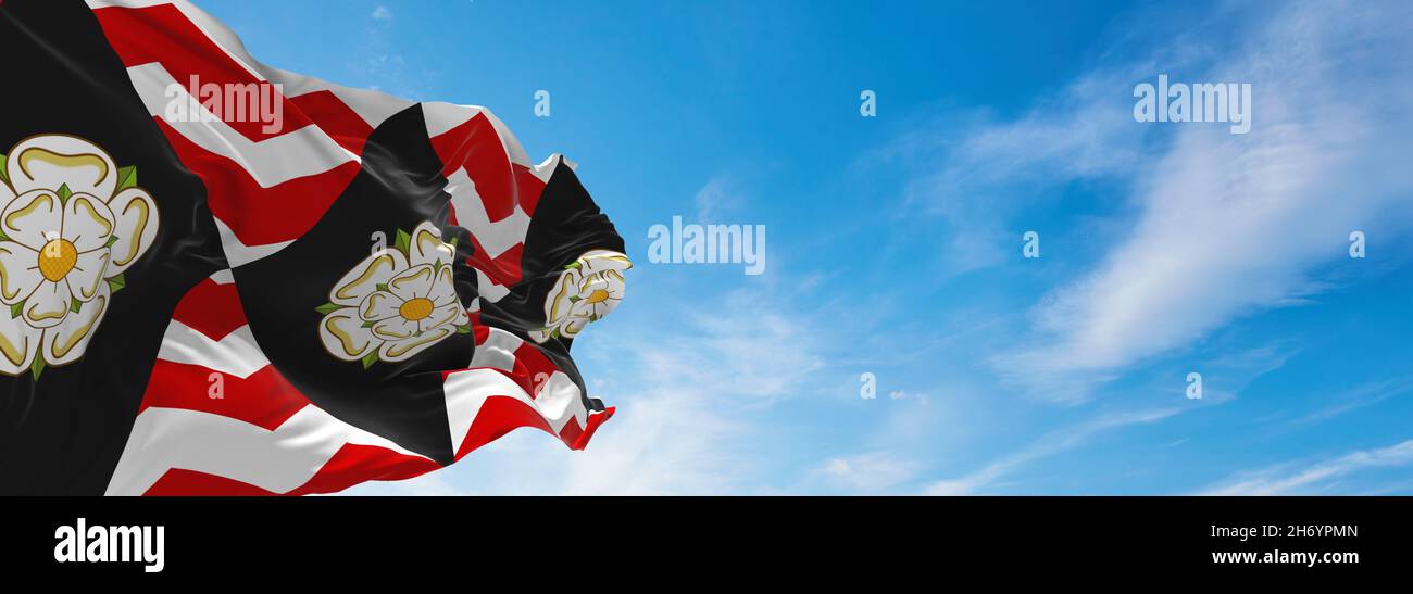 flag of county SouthYorkshire, UK at cloudy sky background on sunset ...