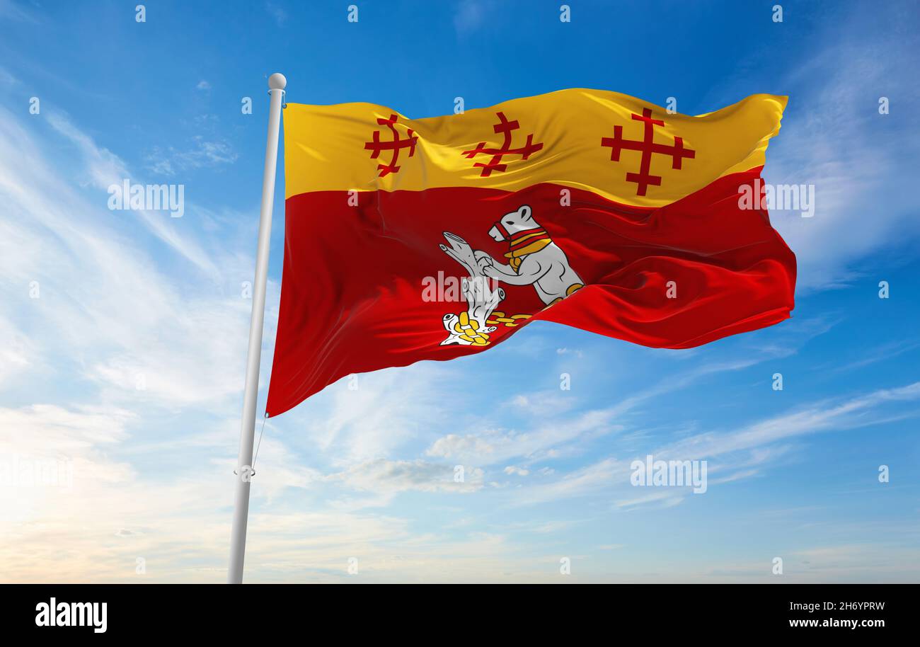 flag of county Warwickshire, UK at cloudy sky background on sunset ...