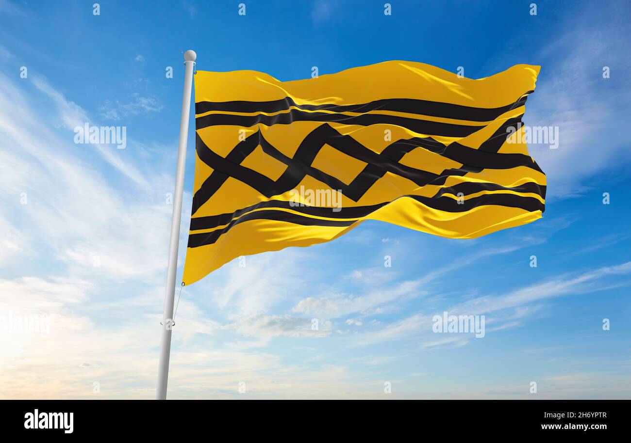 flag of county West Midlands, UK at cloudy sky background on sunset ...