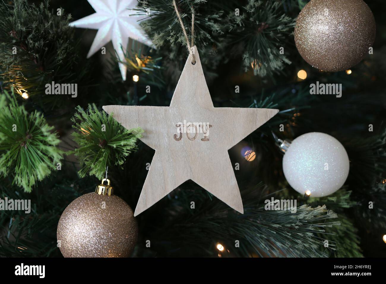Wooden Joy Star Ornament Hanging on the Christmas Tree with Fairy ...
