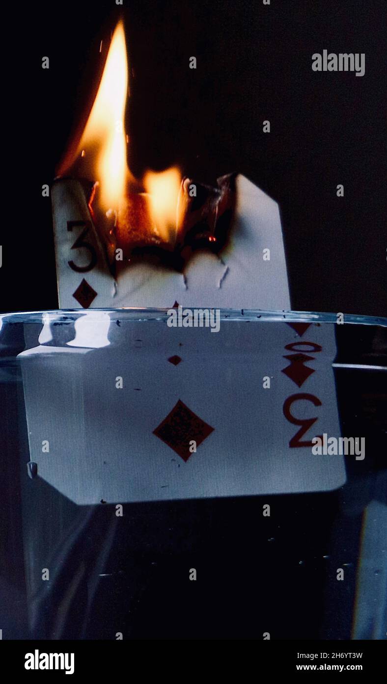 Burning playing card with red hot flames isolated on black background ...