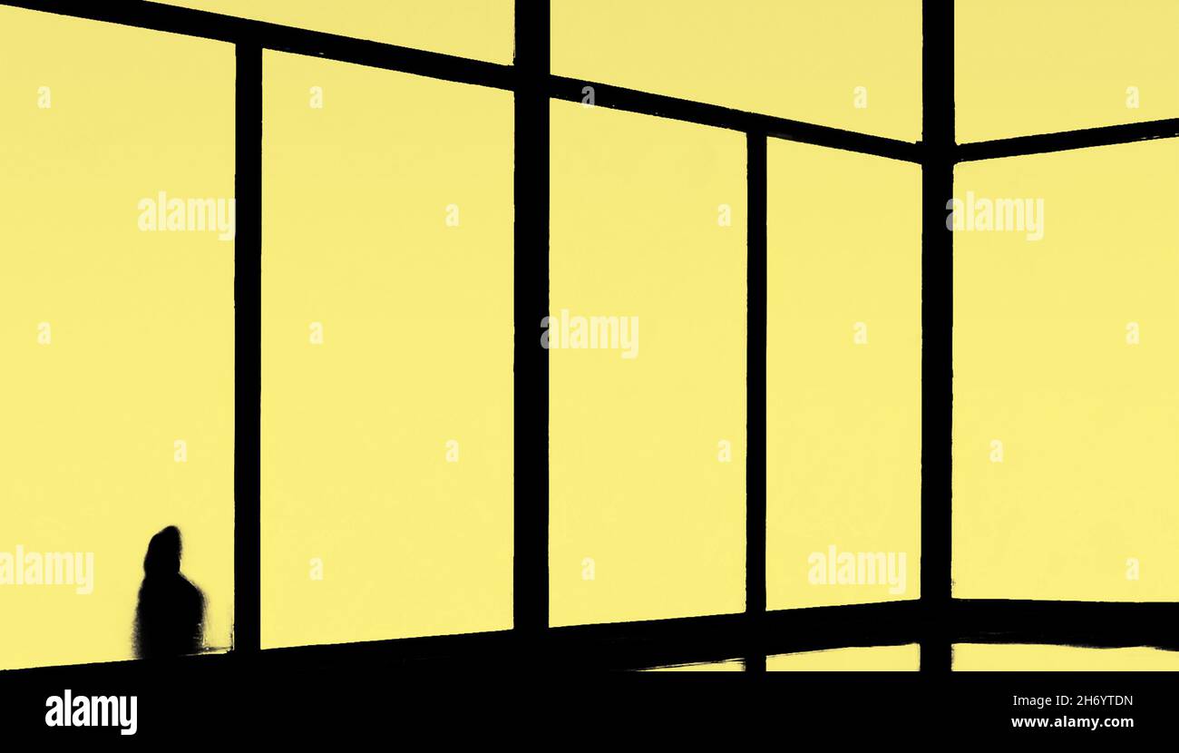 Single person standing near the yellow windows.Perfect for wallpaper ...
