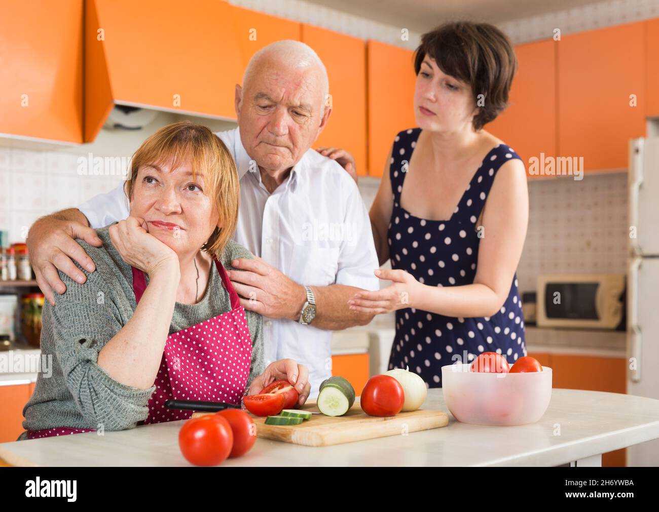 Family supporting upset woman Stock Photo - Alamy