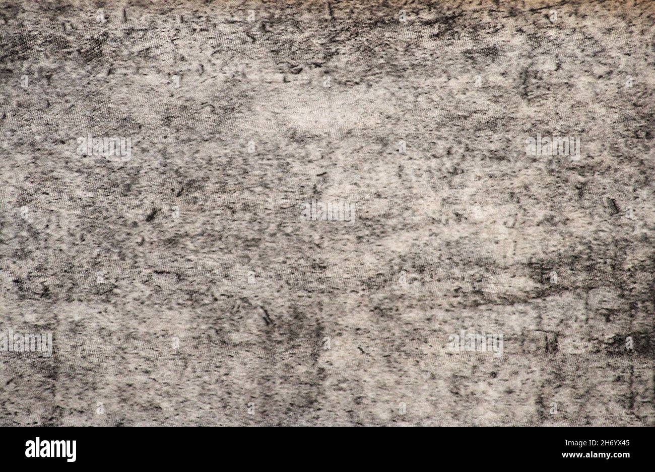 A flat surface of natural light gray stone with traces of processing ...