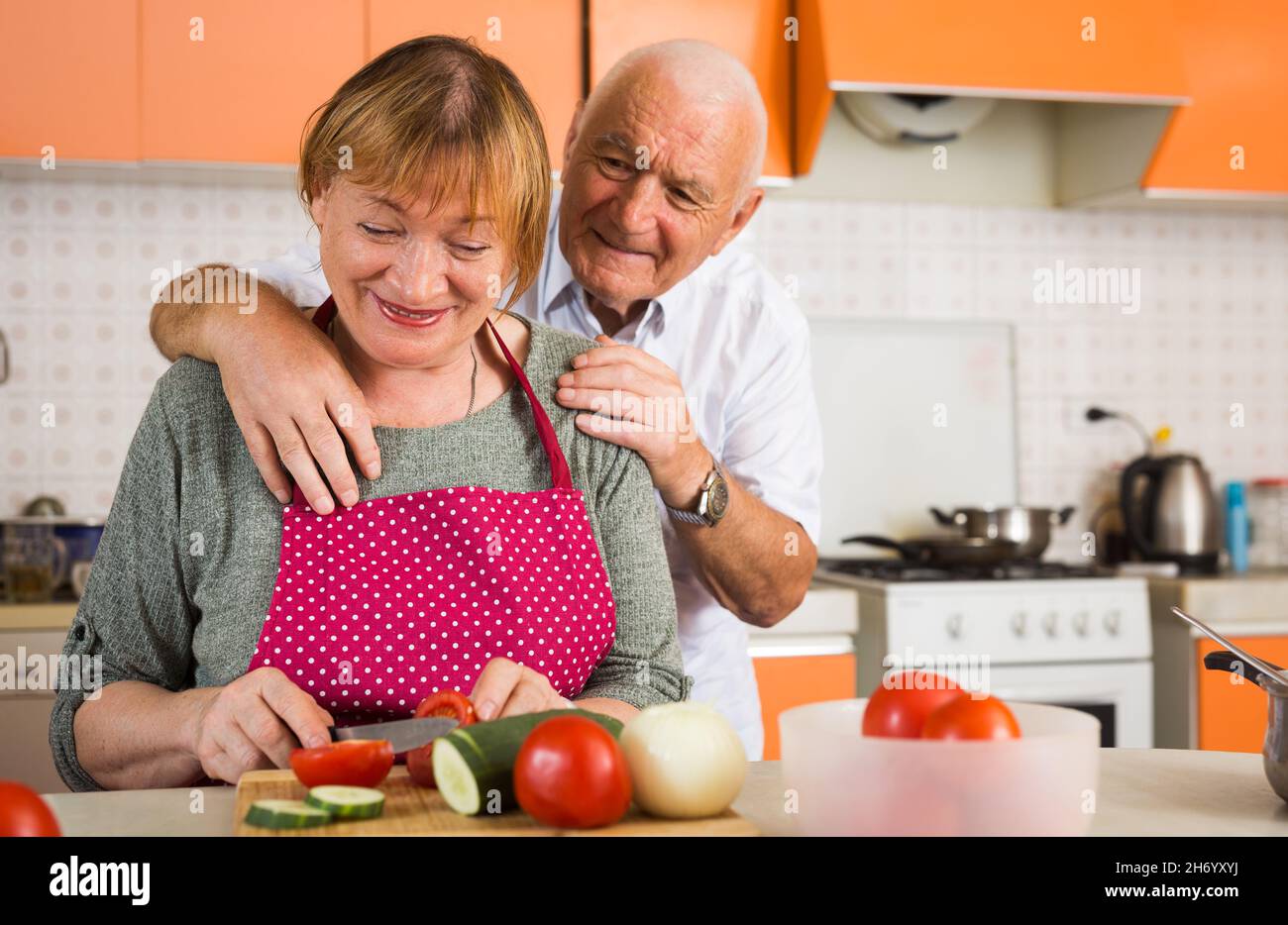 Happy aged couple cooking Stock Photo - Alamy