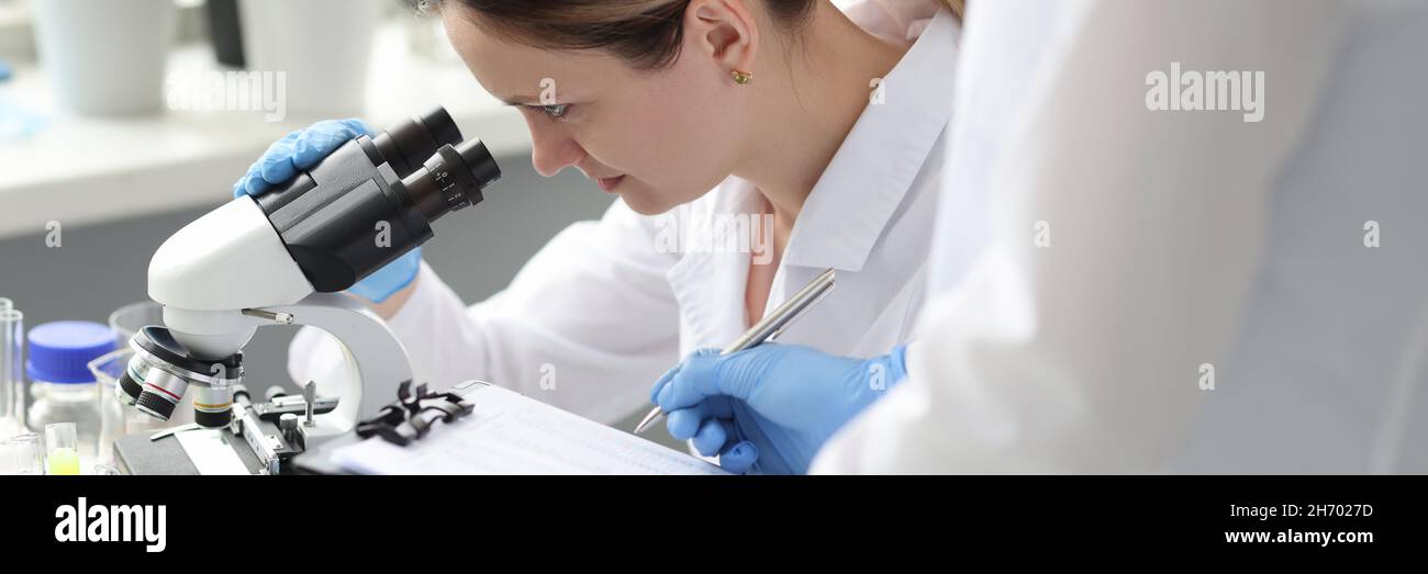 Woman scientist conducts test of chemical composition of substance ...