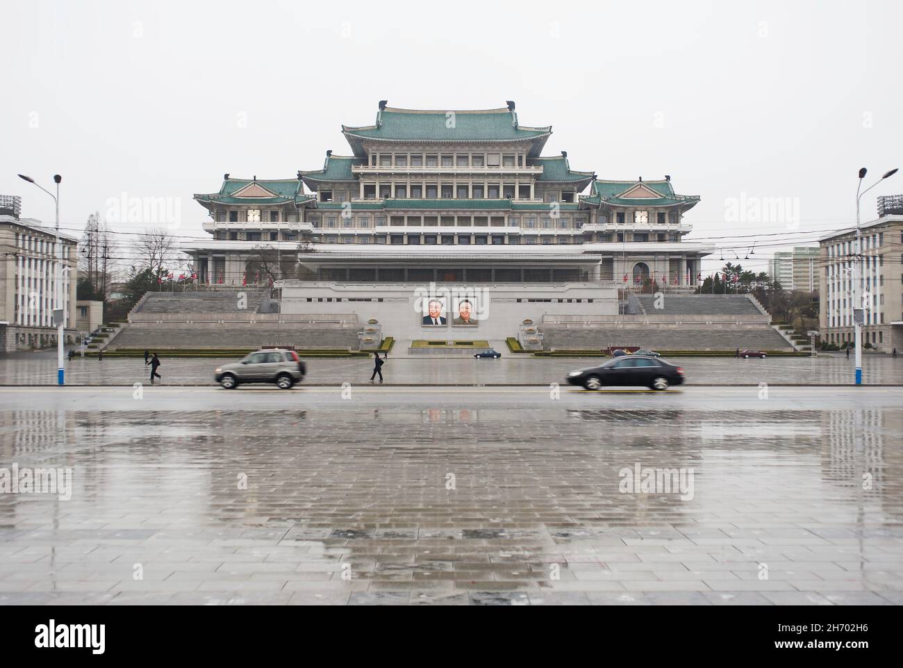 Portraits of Kim Il-Sung and Kim Jong-il hang from the Grand People's ...