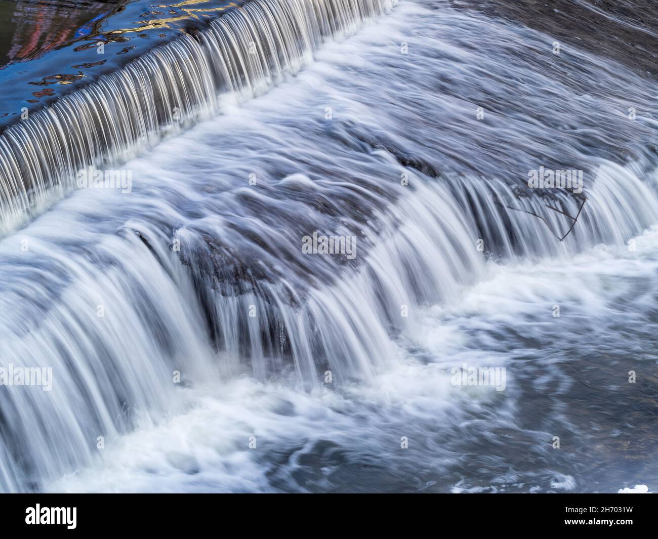 A small flat cascade in a calm river. Water background Stock Photo - Alamy