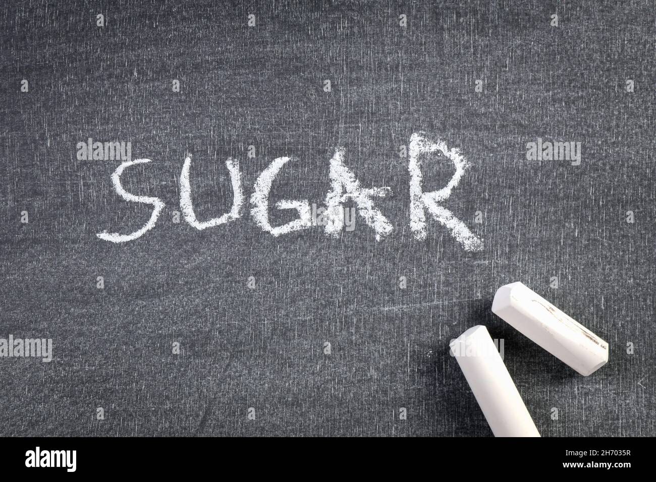 Sugar. Text written in white chalk on a blackboard Stock Photo - Alamy