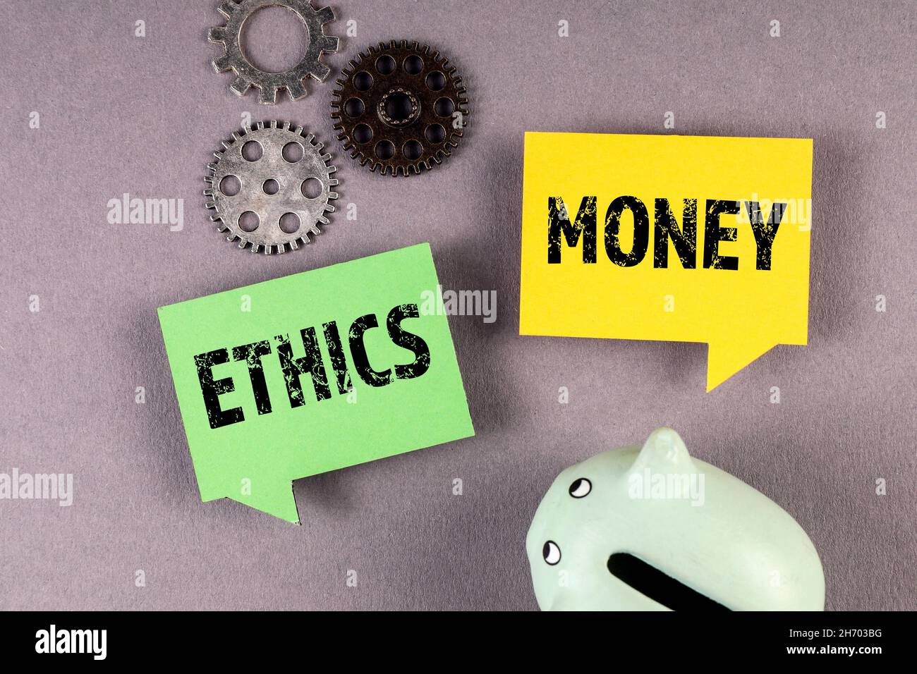 Money and Ethics concept. Speech bubbles, savings bank and gears on a ...