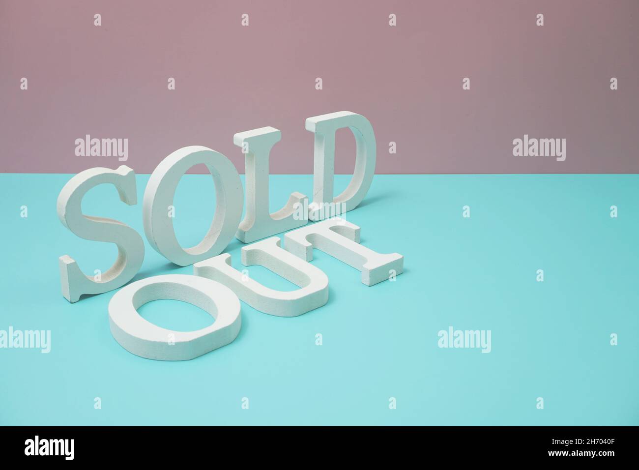 Sold Out alphabet letter on blue and pink background Stock Photo - Alamy