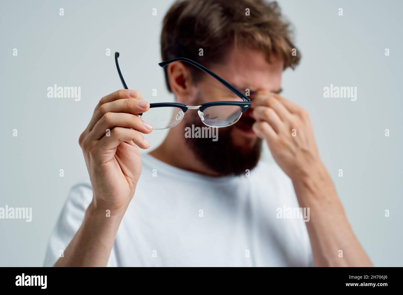 bearded man with poor eyesight health problems close-up Stock Photo - Alamy