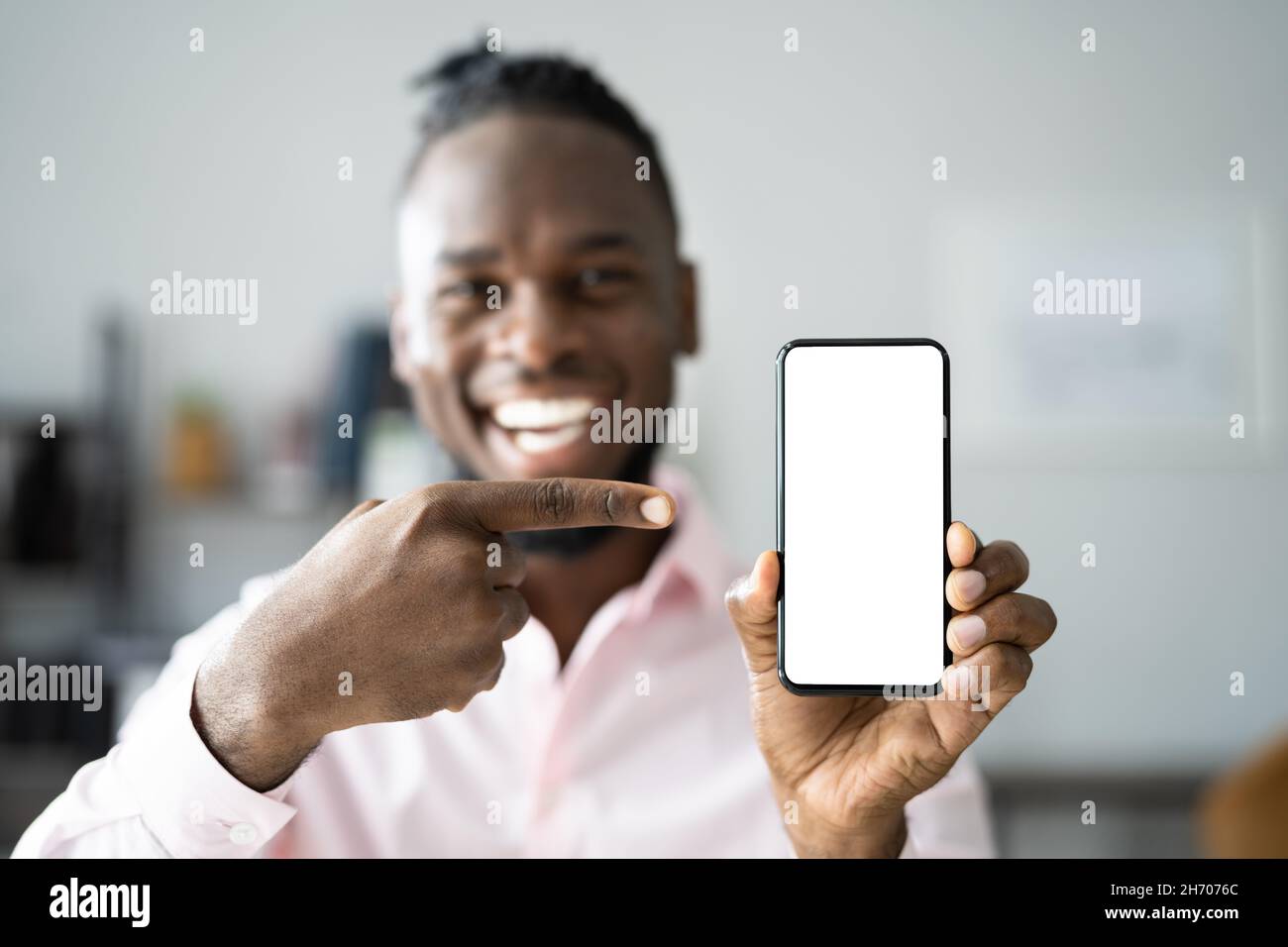 African Man Holding Cellphone Or Mobile Phone Stock Photo - Alamy