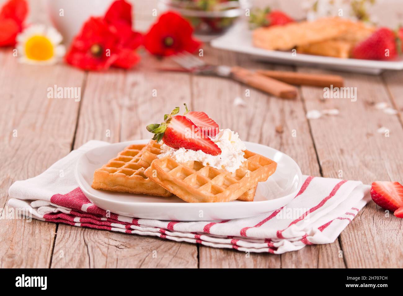 Waffles with strawberries and whipped cream Stock Photo - Alamy