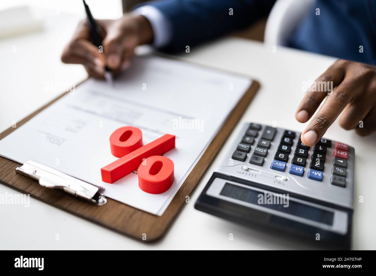 Red Percentage Symbol In Front Of Businessperson Calculating Invoice ...