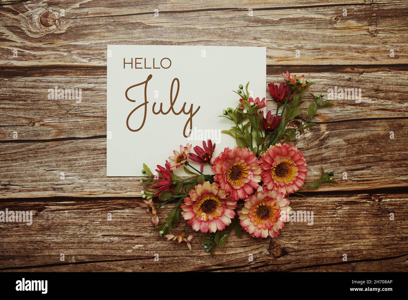 Hello July typography text with flowers on wooden background Stock ...