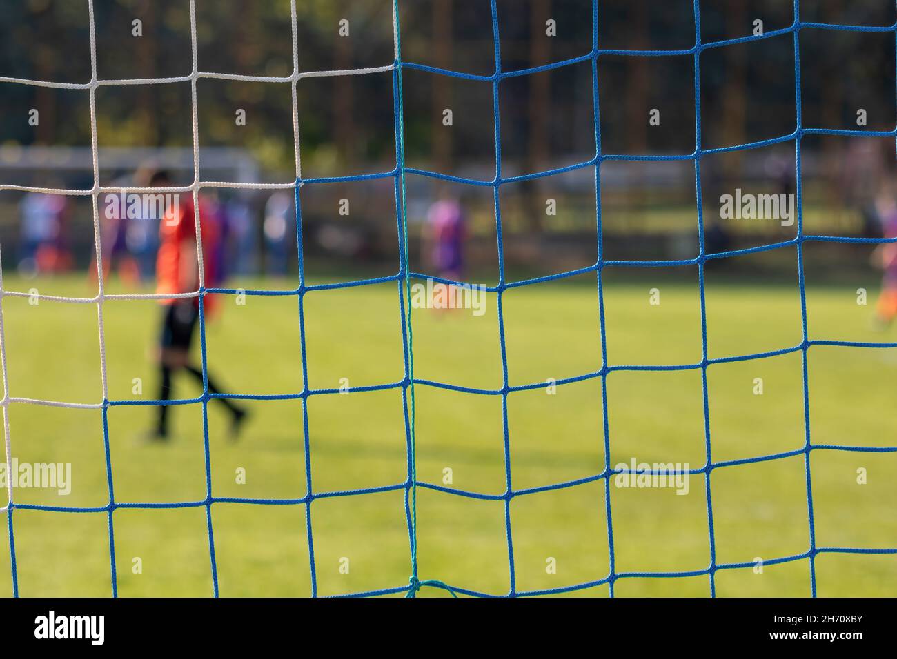 Soccer players through goal nets hi-res stock photography and images ...