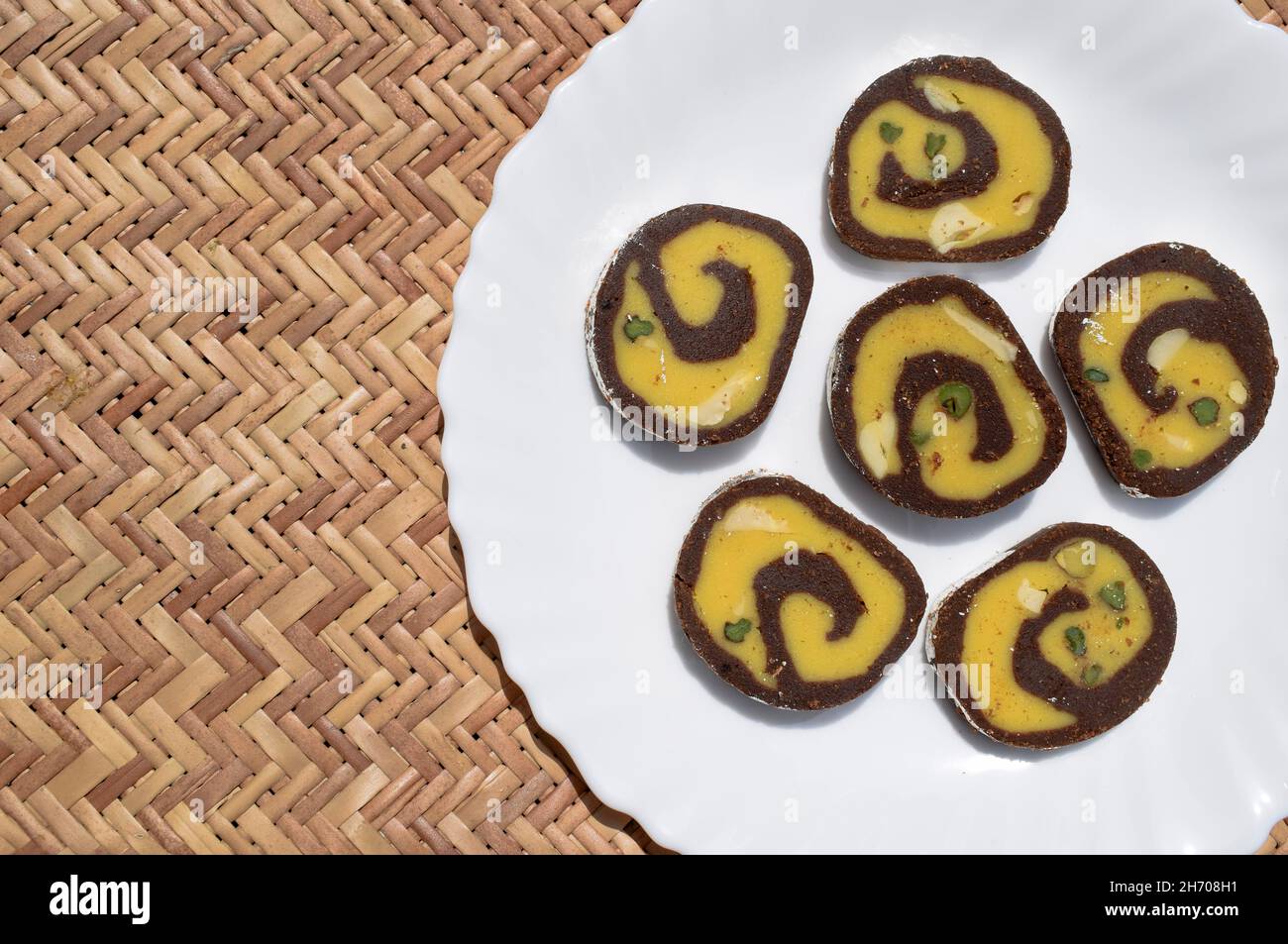 Indian sweet dish called Chocolate barfi roll. Burfi is milk based ...