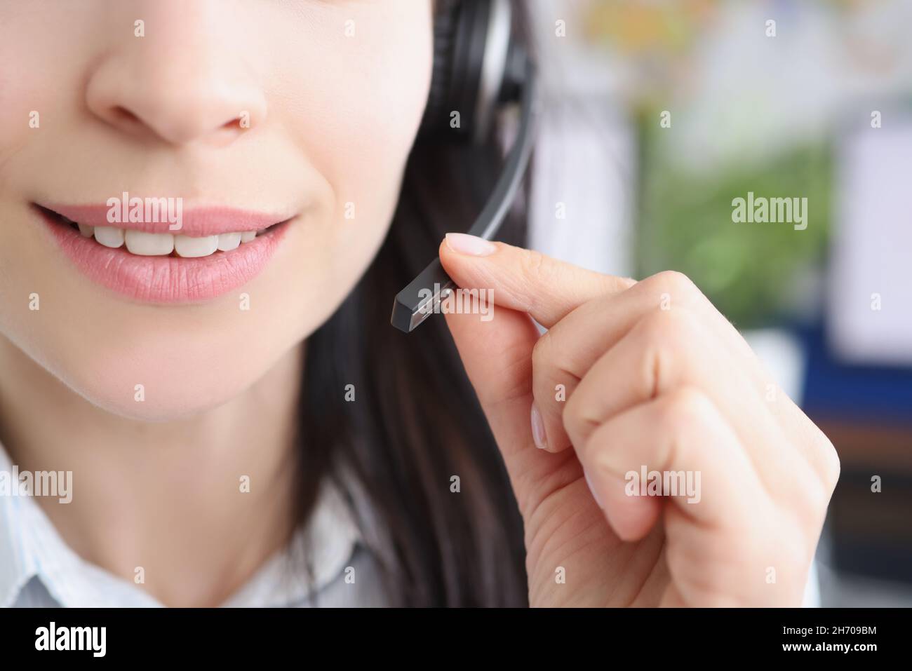 Female support service worker and small microphone for voice connection ...