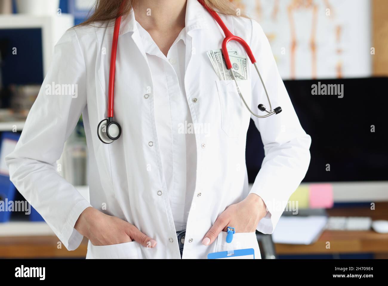 Head doctor in clinic with bunch of money in pocket of medical gown ...