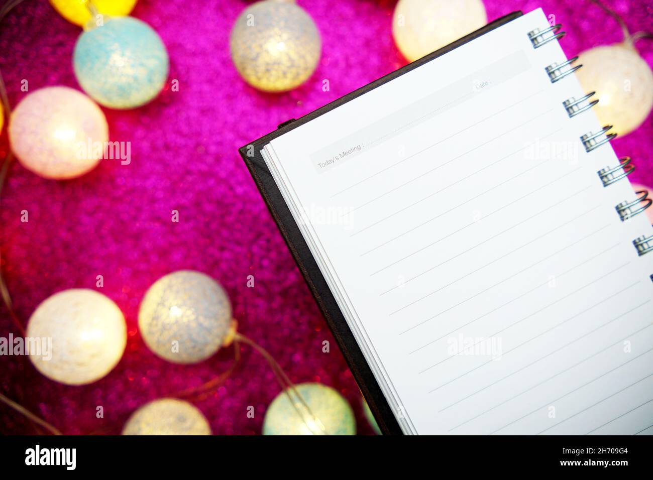 Empty notepad mockup and LED cotton balls decoration on pink bokeh ...