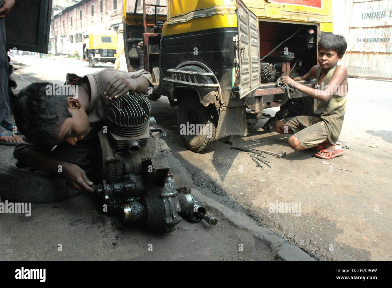 Child labor working in a tree wheeler garage. India Stock Photo - Alamy