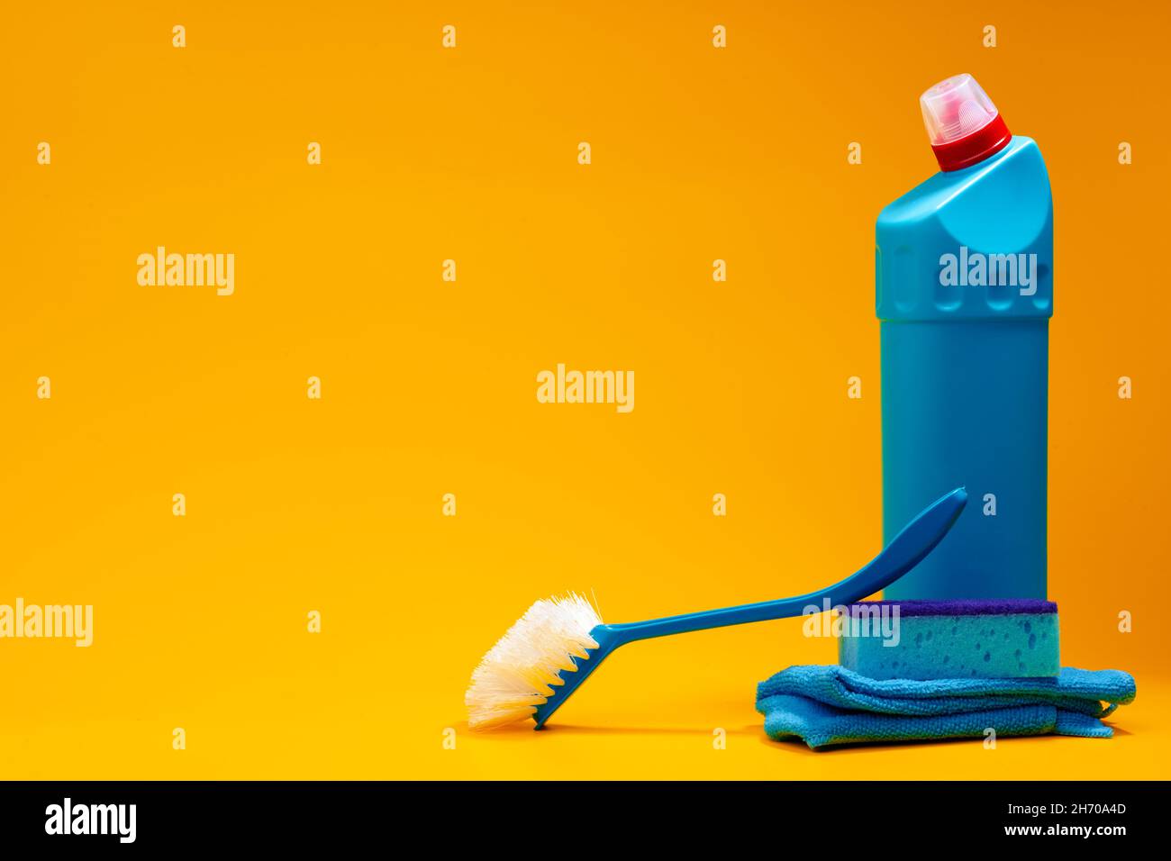 Home cleaning tools on yellow studio background Stock Photo - Alamy