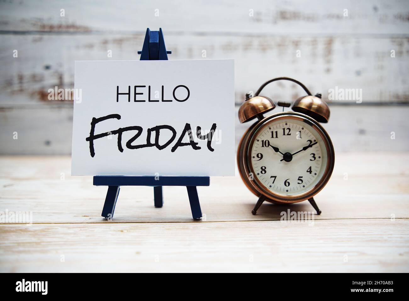 Hello Friday text with alarm clock on wooden background Stock Photo - Alamy