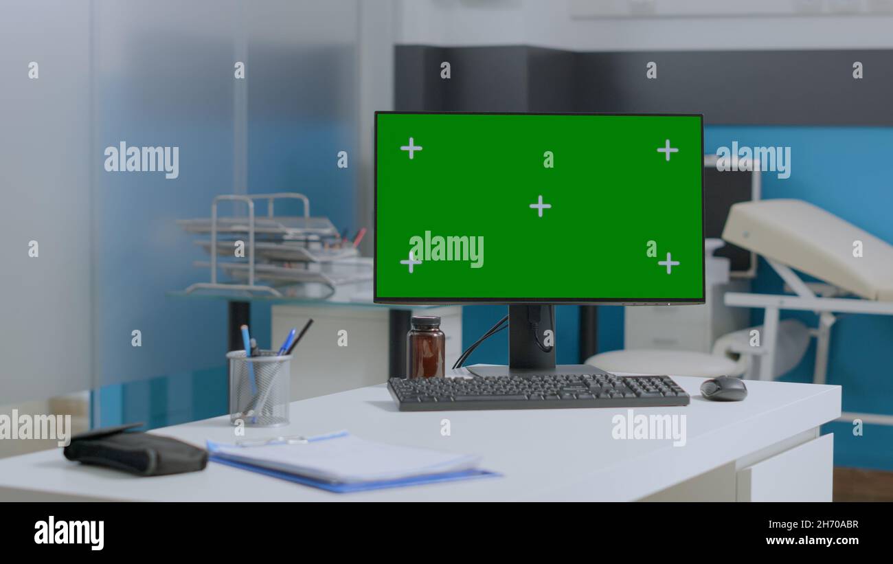 Empty hospital office equipped with mock up green screen chroma key computer with isolated ...