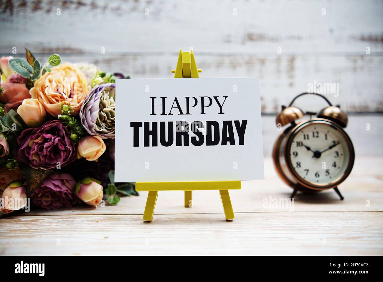 Happy Thursday text with flower bouquet and alarm clock on wooden ...