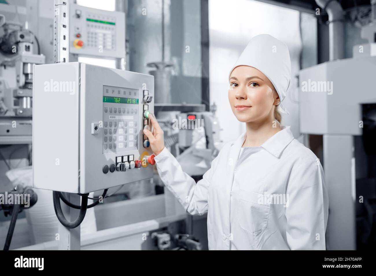 Woman operating work on food conveyor switchboard engineer machine ...