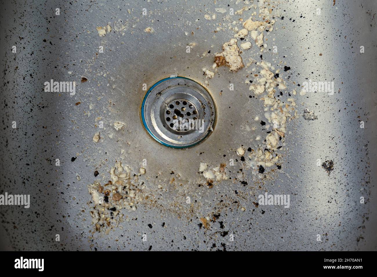 Stainless steel kitchen sink with food and grease residues. Bathroom ...