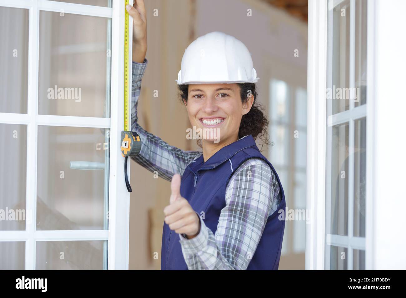 a woman fixing window frame Stock Photo - Alamy