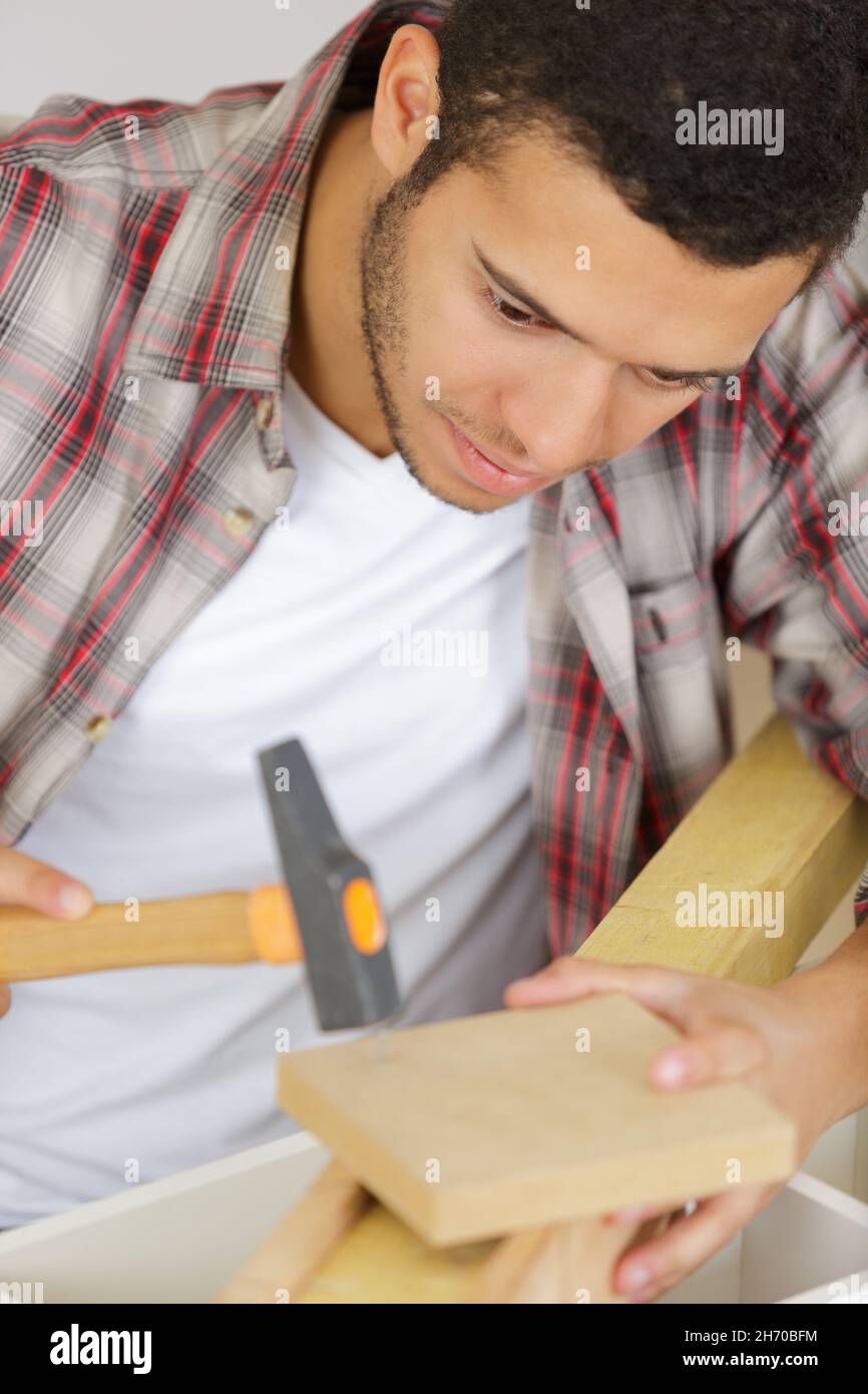 carpenter using hammer on wood Stock Photo - Alamy