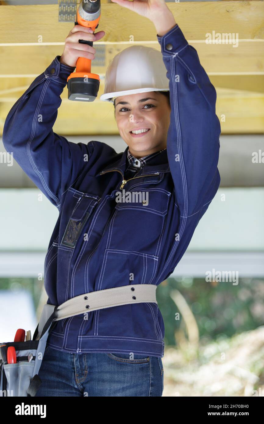 female carpenter at work using hand drilling machine Stock Photo - Alamy