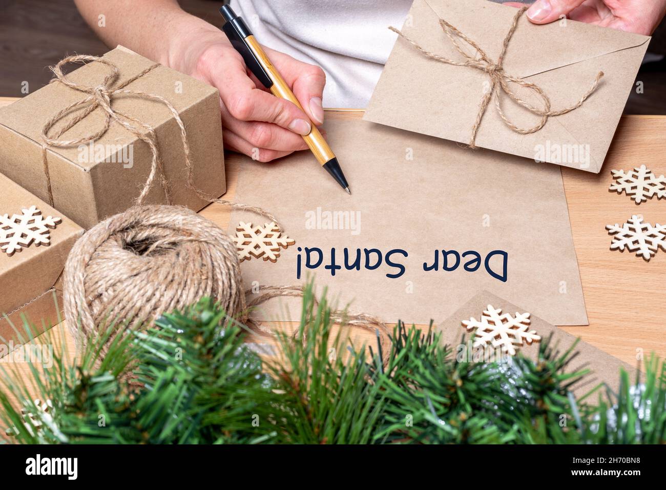 A woman asks Santa for Happiness. Female hand writing a Christmas ...