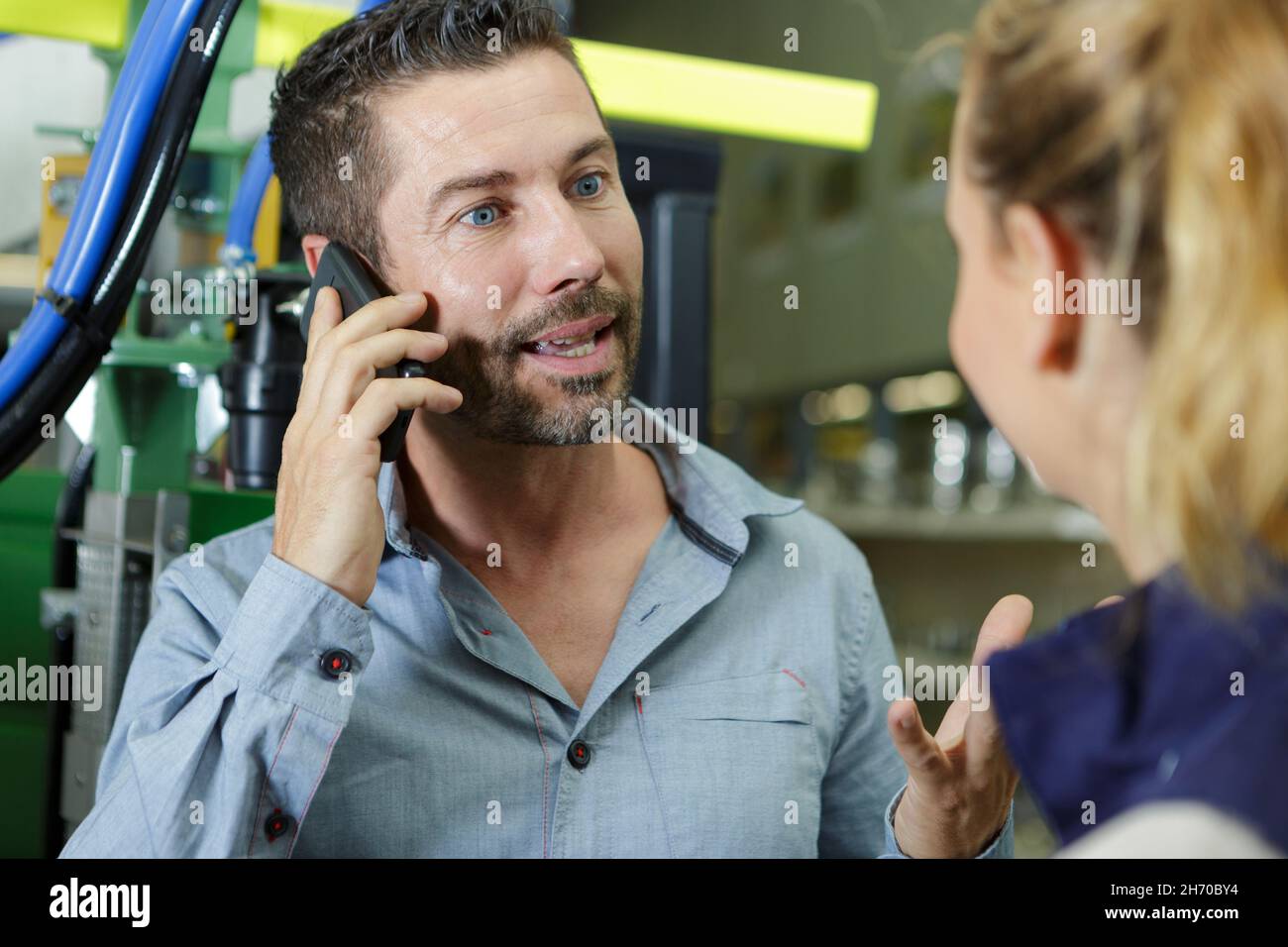 factory workers dealing with customer on the phone Stock Photo - Alamy