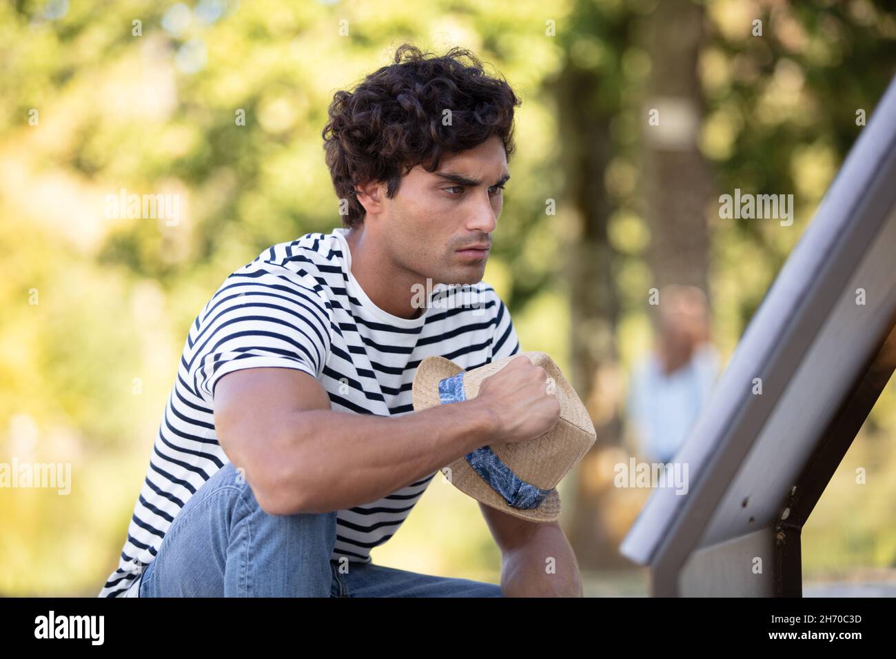 a funny young man reading a sign Stock Photo - Alamy