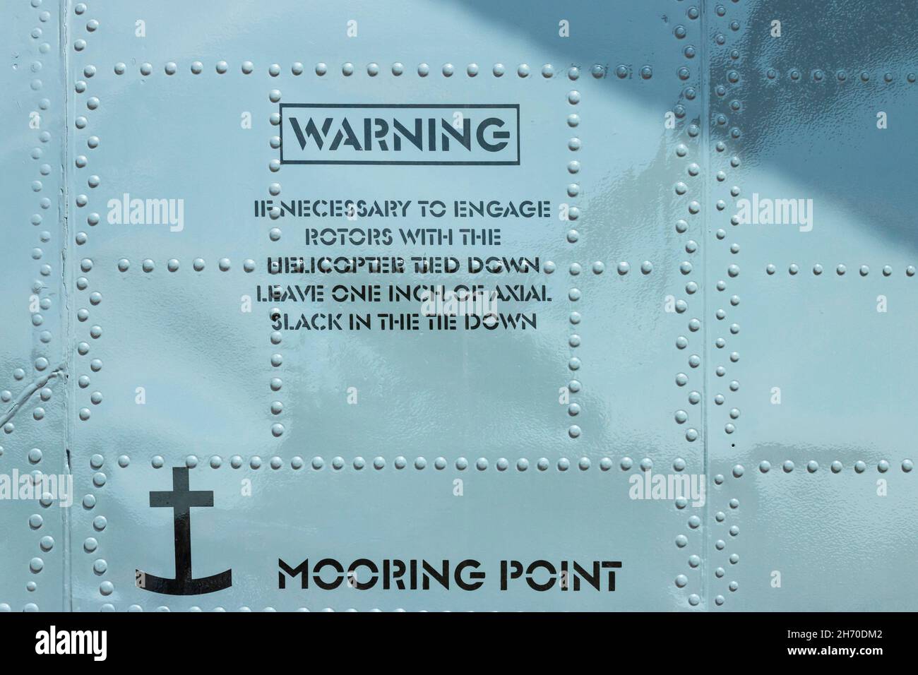 close up of stencilled painted warning sign on side of military ...