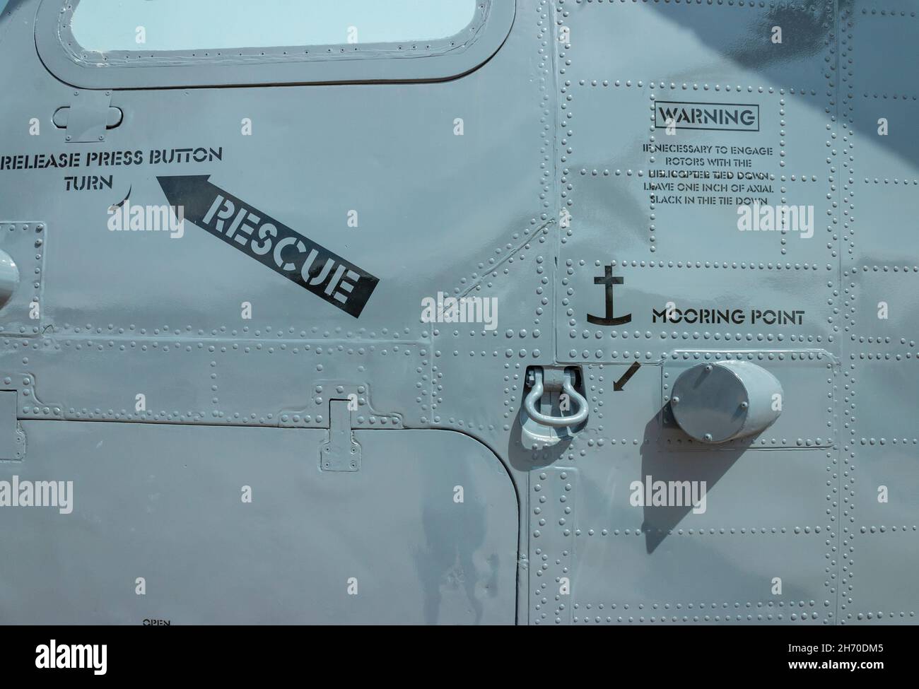 close up of stencilled painted rescue warning sign on side of military ...