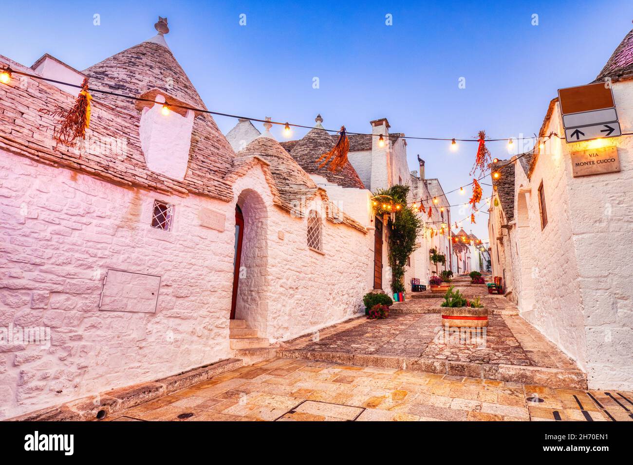 Famous Trulli Houses in Alberobello Illuminated at Dusk, Puglia, Italy ...