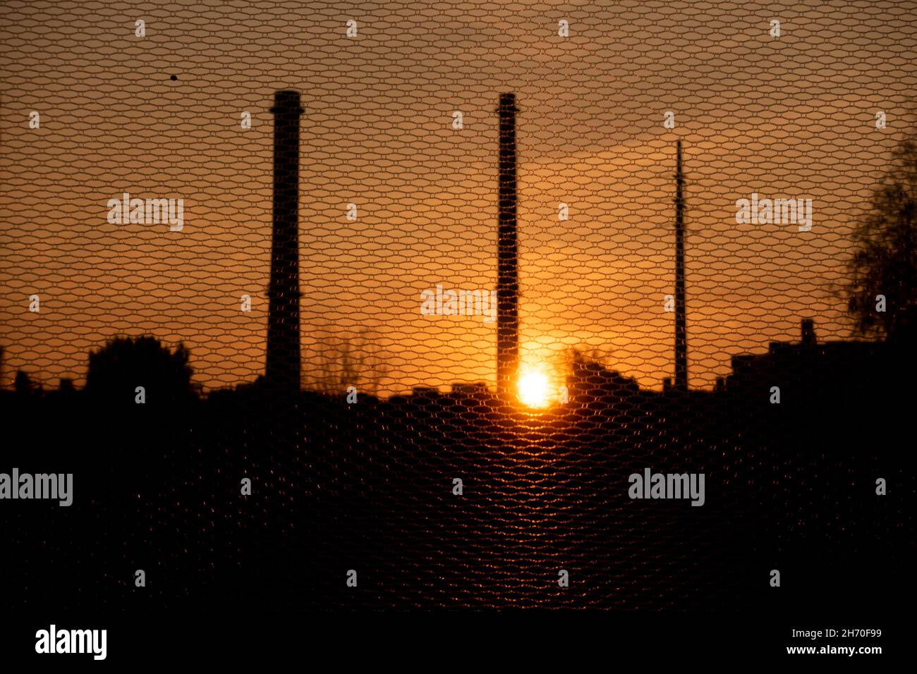 Silhouette of industrial factories under a sunset sky Stock Photo - Alamy