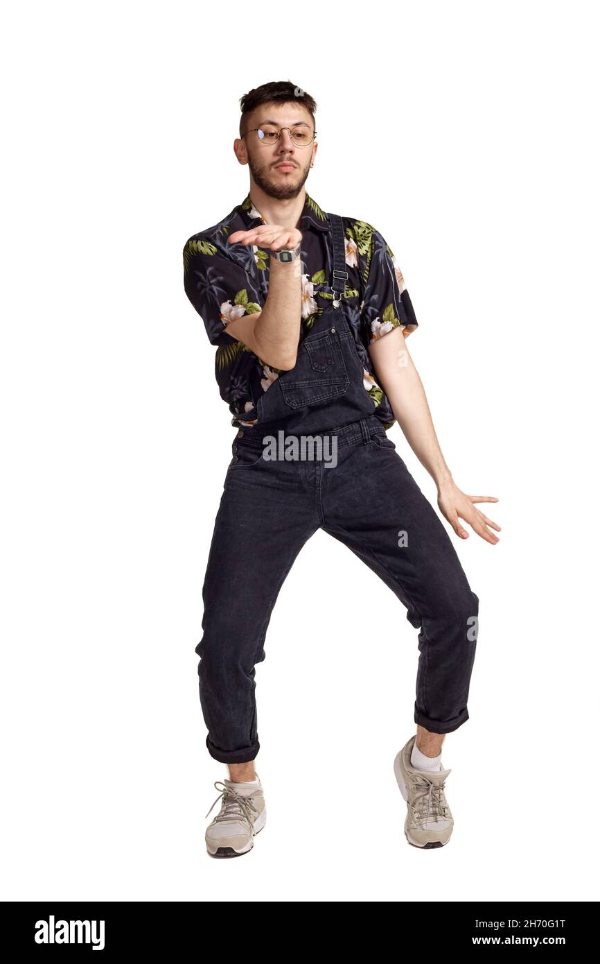 Full-length portrait of a funny guy dancing in studio isolated on white ...