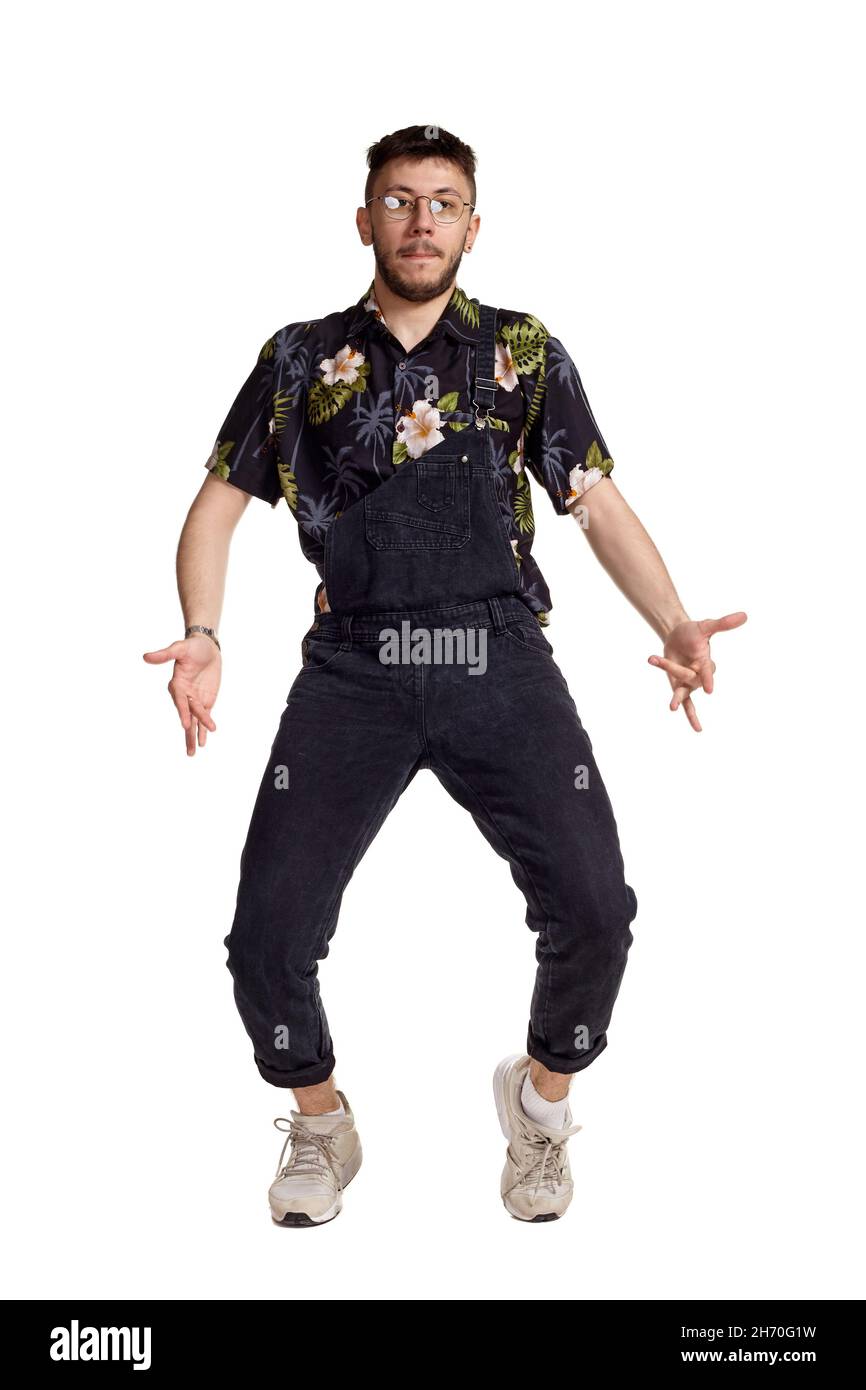 Full-length portrait of a funny guy dancing in studio isolated on white ...