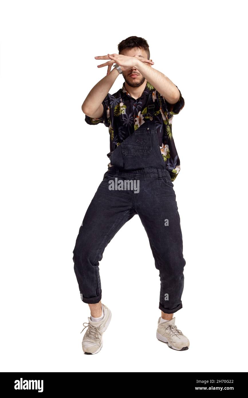 Full-length portrait of a funny guy dancing in studio isolated on white ...