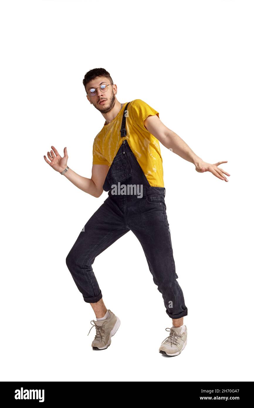 Full-length portrait of a funny guy dancing in studio isolated on white ...